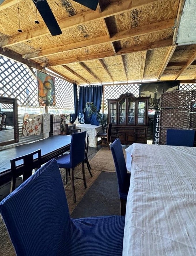 Eclectic artwork and cozy seating create a welcoming atmosphere that feels like dining in a friend's backyard.