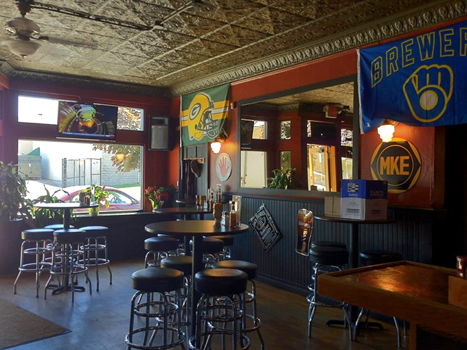 Milwaukee sports pride on full display with Brewers and Packers flags adorning walls where high-top tables invite casual conversation and impromptu celebrations.