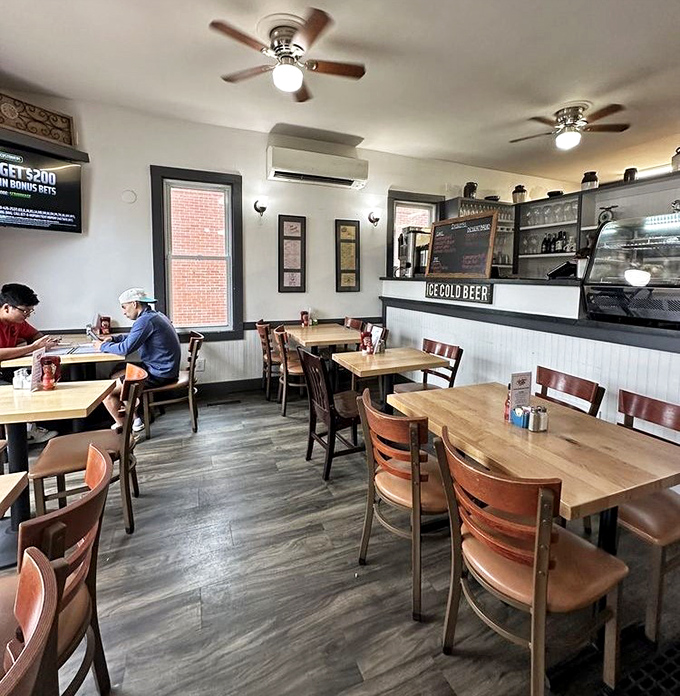 Modern comfort meets classic diner aesthetic&mdash;wooden tables, comfortable chairs, and the promise of "COLD BEER" for those post-breakfast return visits.