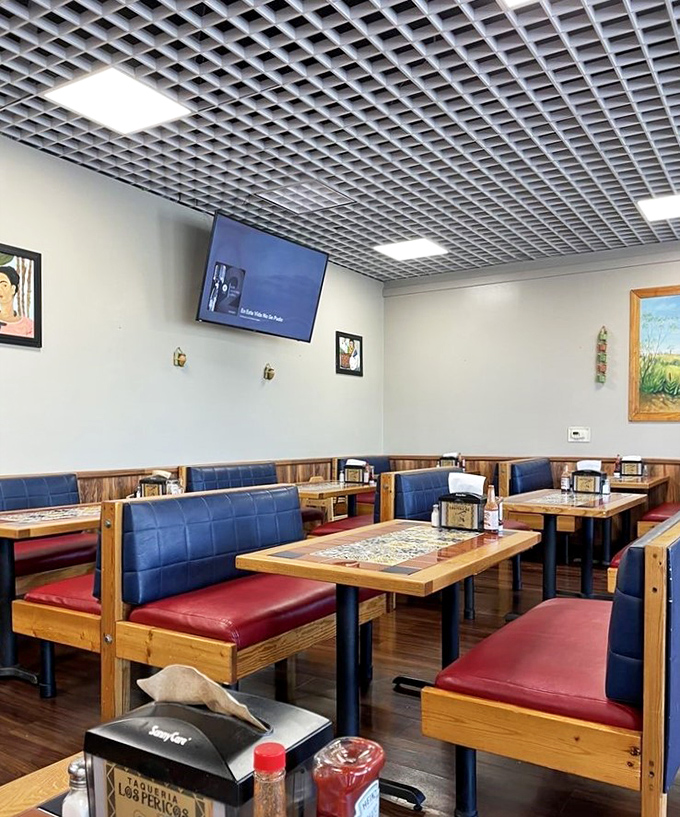 The dining room waits patiently between rushes, its blue booths and wooden tables standing by like old friends ready for your next taco-fueled heart-to-heart.