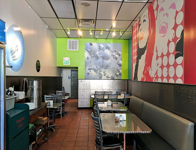 Modern art meets modern appetite in this dining space. Those green walls are practically shouting, "Yes, you should order another pizza!"