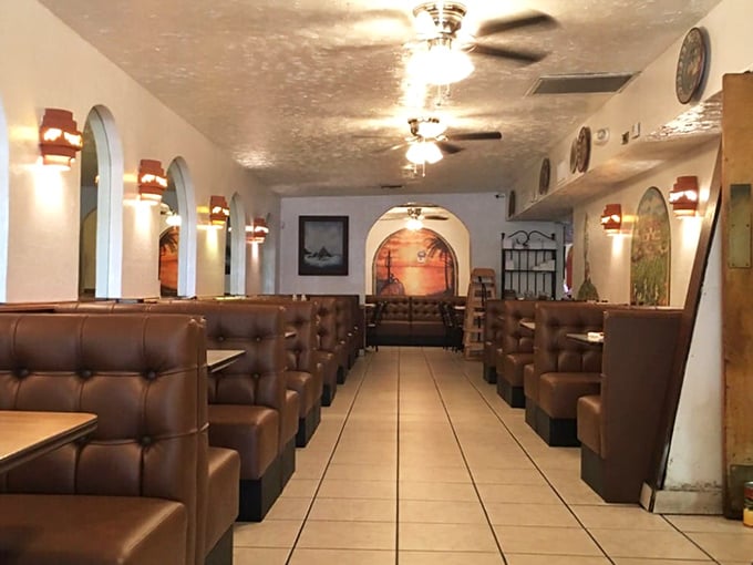 The restaurant's layout creates a pathway to deliciousness, with brown leather booths lining both sides like tasty treasures waiting to be discovered.