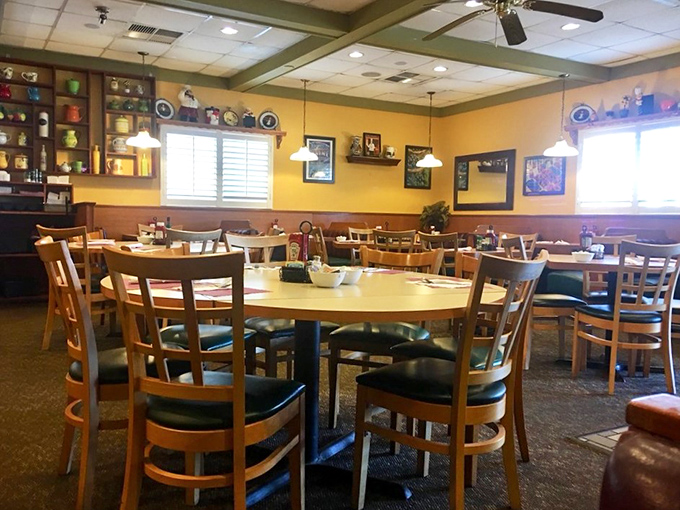 Yellow walls, wooden accents, and display shelves create that "grandma's kitchen got an upgrade" vibe we all secretly crave.