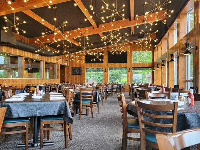 Dining under a constellation of starburst lights makes every meal feel like a special occasion. The wood-paneled walls practically radiate warmth.