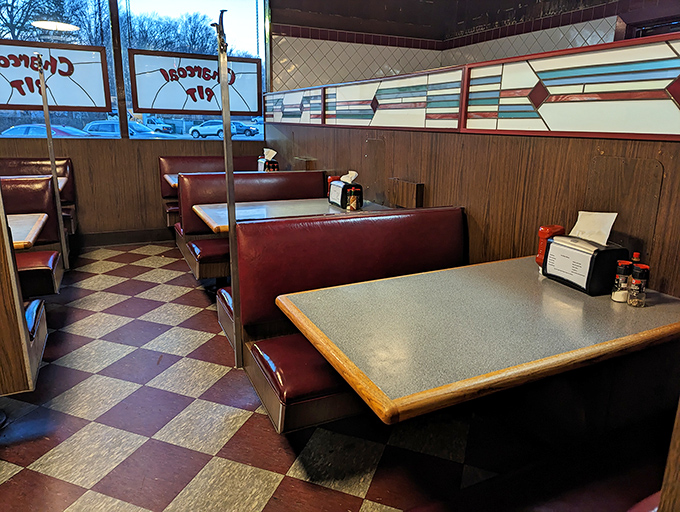 Red booths against wood paneling create the perfect backdrop for family gatherings. This isn't dining; it's a Delaware tradition served tableside.