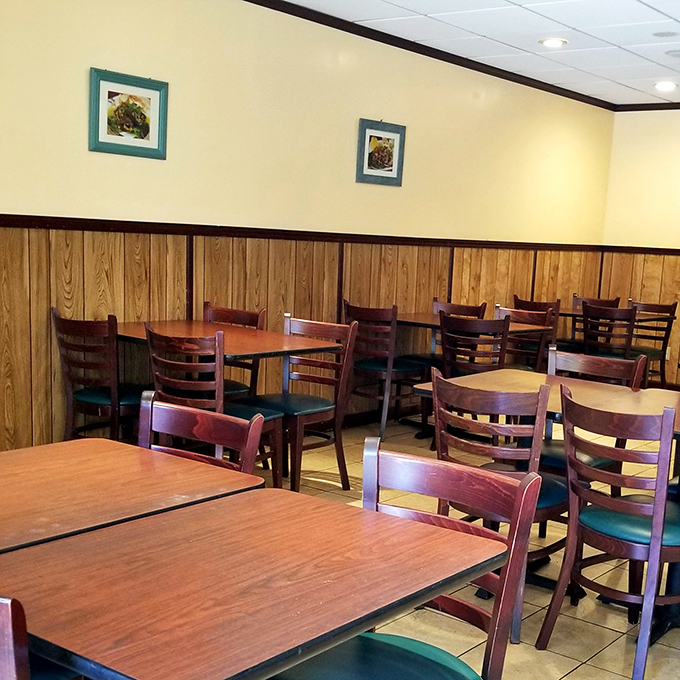 Wooden wainscoting and simple furnishings create an unpretentious atmosphere where the food, not the decor, takes center stage.