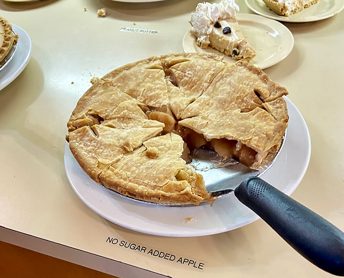 Apple pie tall enough to require structural engineering, sweet enough to make your dentist weep with joy.