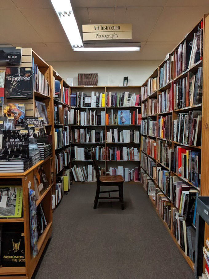 The art and photography aisle, where a simple wooden stool invites you to sit and contemplate coffee table acquisitions.