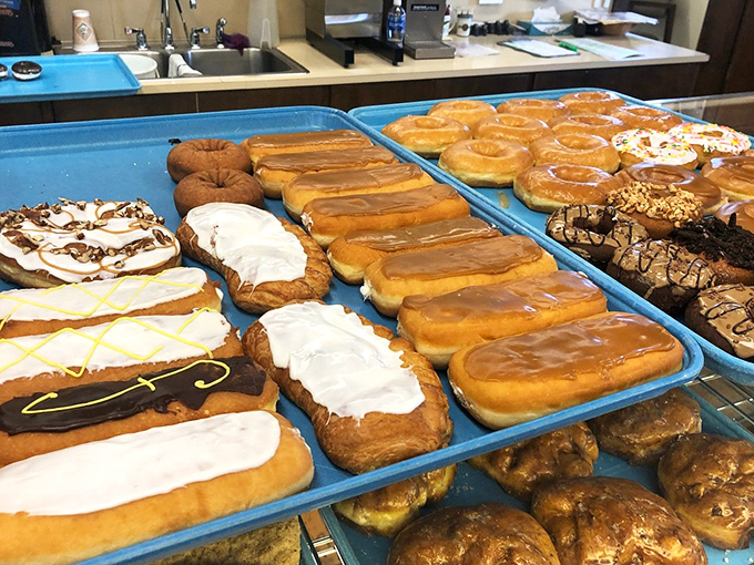 Long trays of donuts in various states of delicious dress&mdash;some glazed, some frosted, all plotting to destroy your willpower with surgical precision.