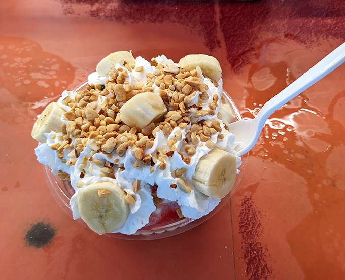 Banana sundae architecture that defies gravity and restraint. Whipped cream, nuts, and sliced bananas create a dessert skyline worth the drive.