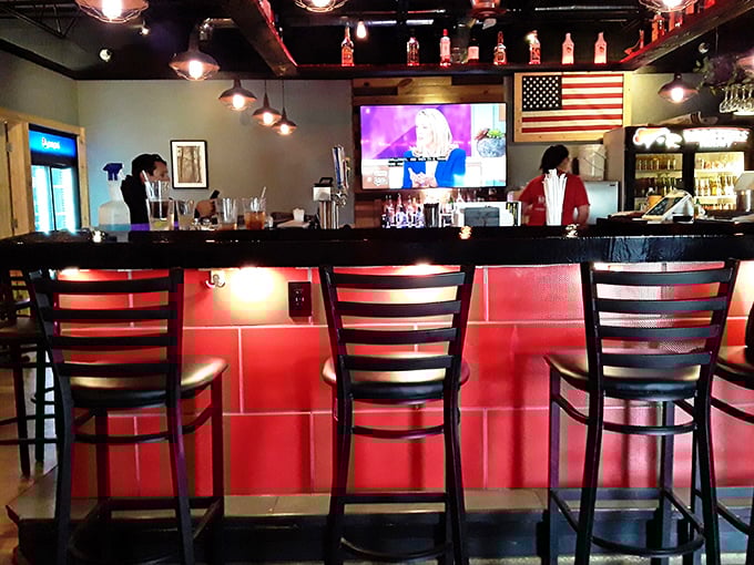 The striking red bar becomes command central for both drinks and good times.