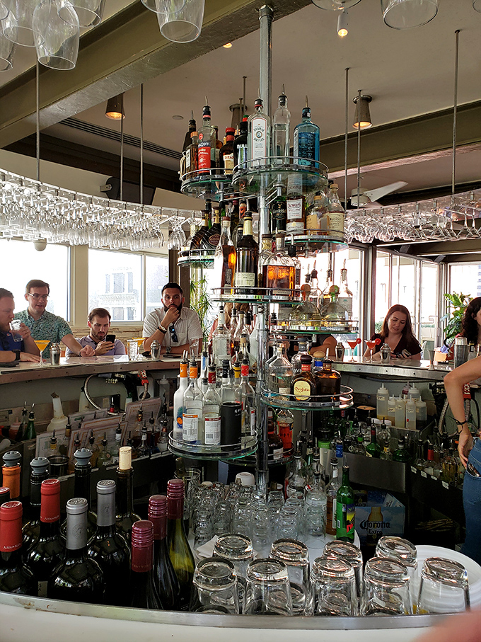 The bar's sculptural bottle display isn't just storage—it's functional art, promising libations crafted with the same creativity as the food menu.
