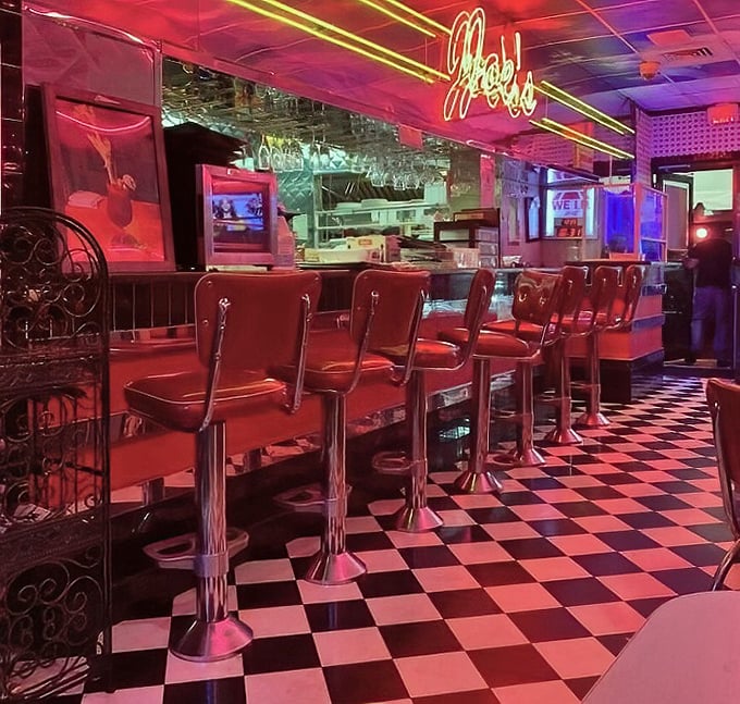 Red vinyl stools lined up like loyal soldiers, ready for the next wave of hungry patrons seeking refuge from cooking at home.