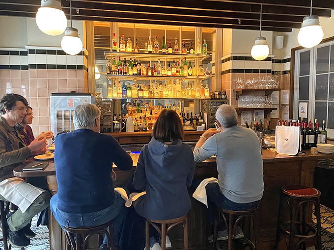 The bar at The Love&mdash;where strangers become friends and friends become family. That backlit bottle display isn't just storage, it's a promise.
