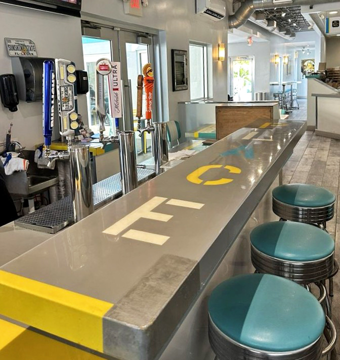 The counter where burger dreams come true, complete with those swiveling stools that somehow make everything taste 20% better.