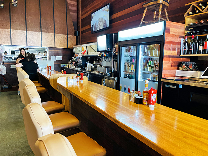 A bar area that balances casual comfort with unexpected elegance, proving diners can indeed have sophisticated souls beneath their humble exteriors.