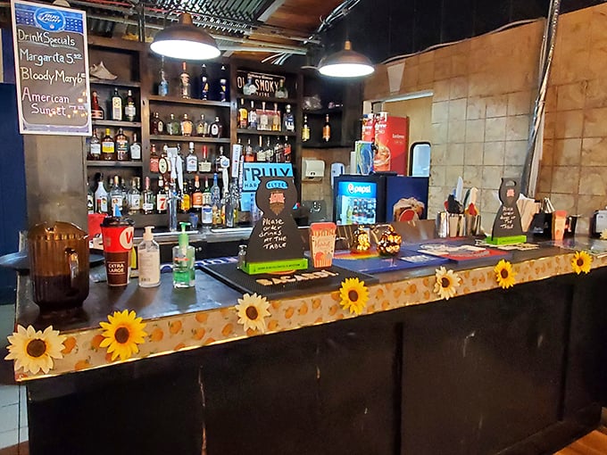 The bar's sunflower trim adds unexpected cheer to your maritime feast. Captain Jim knows a good voyage requires proper libations.