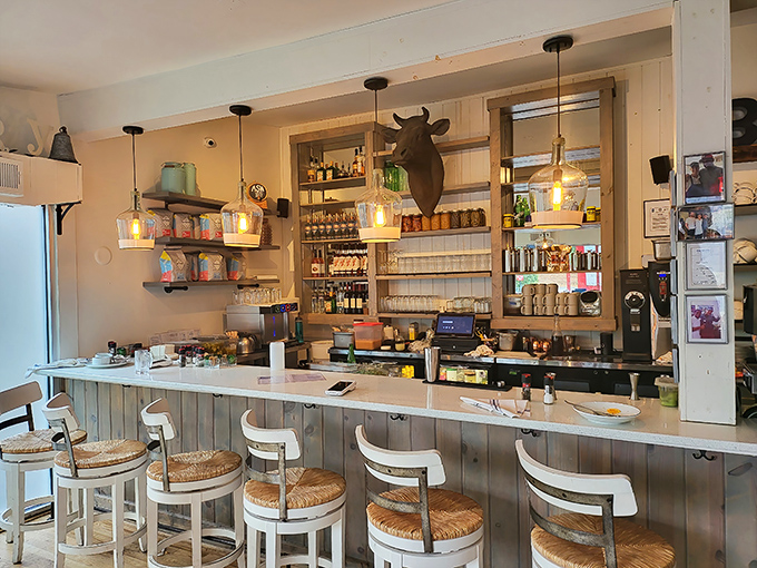 Edison bulbs cast a warm glow over the bar area, where rustic meets refined and every detail feels thoughtfully curated rather than manufactured.