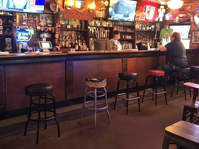 The bar stretches like a runway for comfort food flights. Those stools have supported generations of locals sharing stories, sports debates, and life milestones.