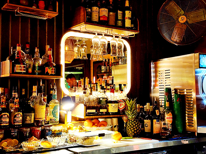 The bar at Little Nickel glows like a tropical sunset, with enough rum varieties to make a pirate weep with joy.