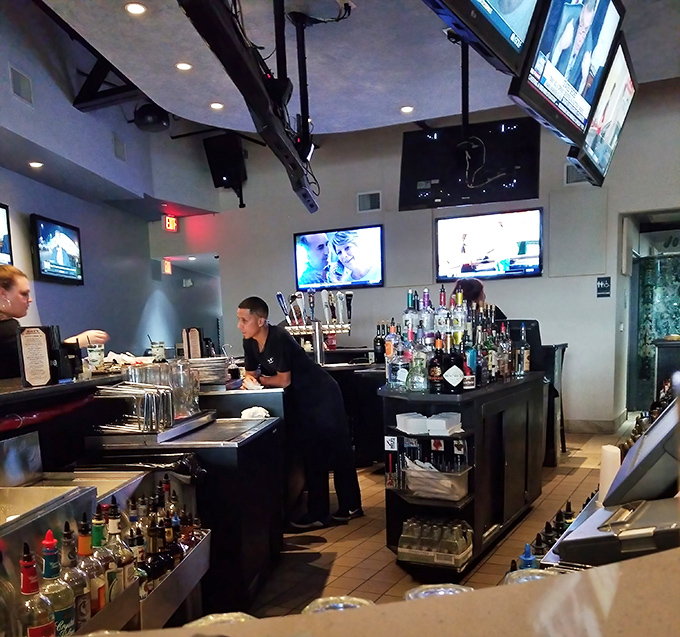The bar area – where sports fans and pasta lovers find common ground. Those TVs ensure you won't miss the game while savoring your spaghetti.