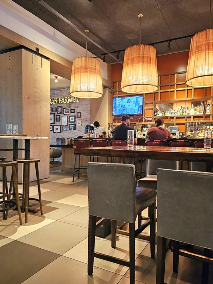 The bar area beckons with warm lighting and the promise of craft cocktails that will make you forget about your usual "I'll just have a beer."