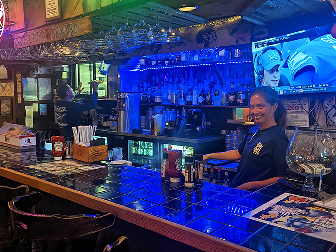 The bar glows with blue light, promising tropical concoctions that pair perfectly with whatever the fishermen brought in today.