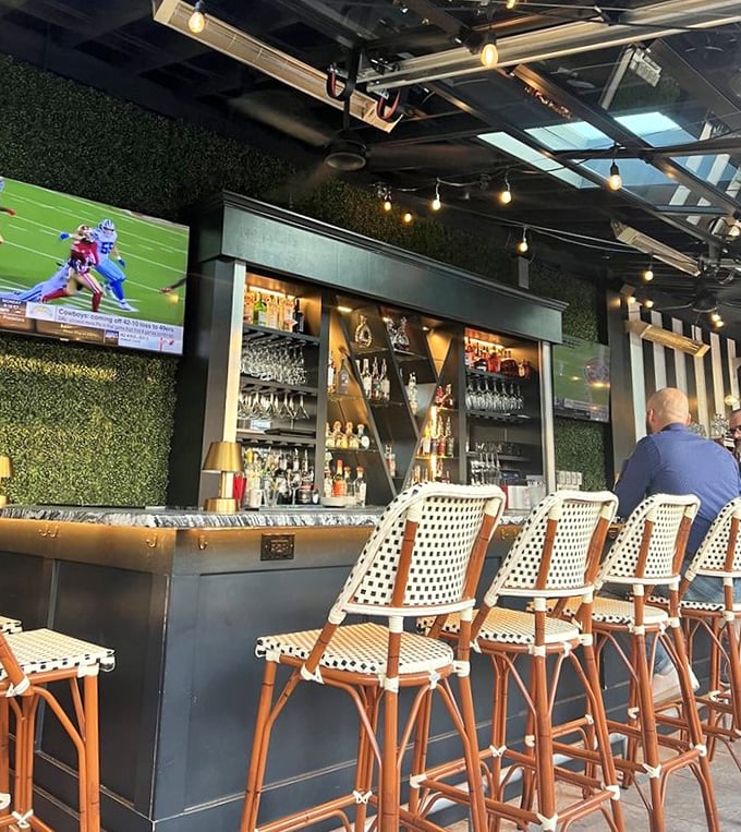 The modern bar area blends contemporary touches with classic steakhouse DNA, proving The Top knows how to evolve while honoring its roots.