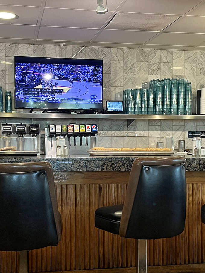 At the counter, where coffee cups are always full and the barstools have supported decades of neighborhood stories and secrets.
