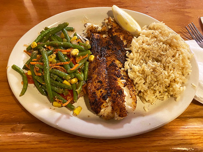 Blackened fish that's found the perfect balance between spice and tenderness, flanked by rice and vegetables that aren't mere afterthoughts.