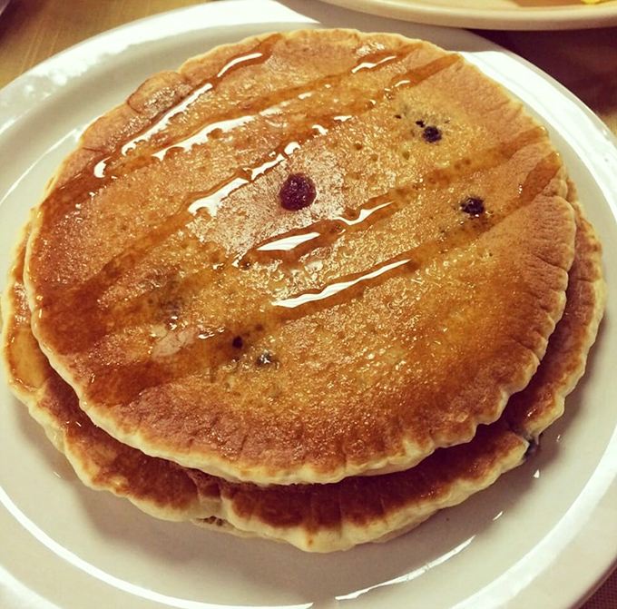 Pancakes with personality &ndash; golden brown with blueberries that burst like tiny flavor bombs. Add maple syrup and watch breakfast become an event.