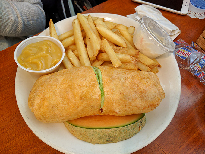 A breakfast burrito that's achieved the perfect filling-to-tortilla ratio, escorted by fries that didn't come from a freezer bag.