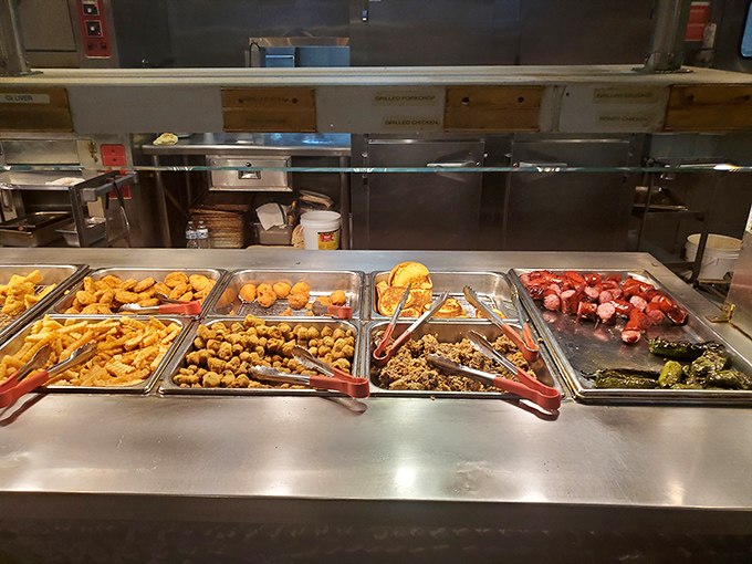 The buffet line stands ready for action, a United Nations of comfort foods where everyone can find their perfect plate companion.