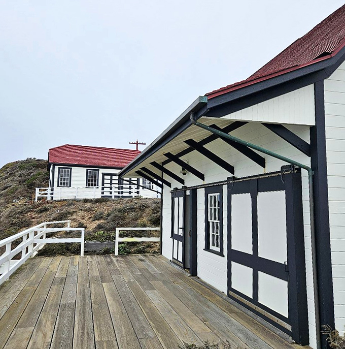 The pristine white buildings with their distinctive red roofs stand in stark contrast to the rugged landscape&mdash;nautical architecture at its finest.