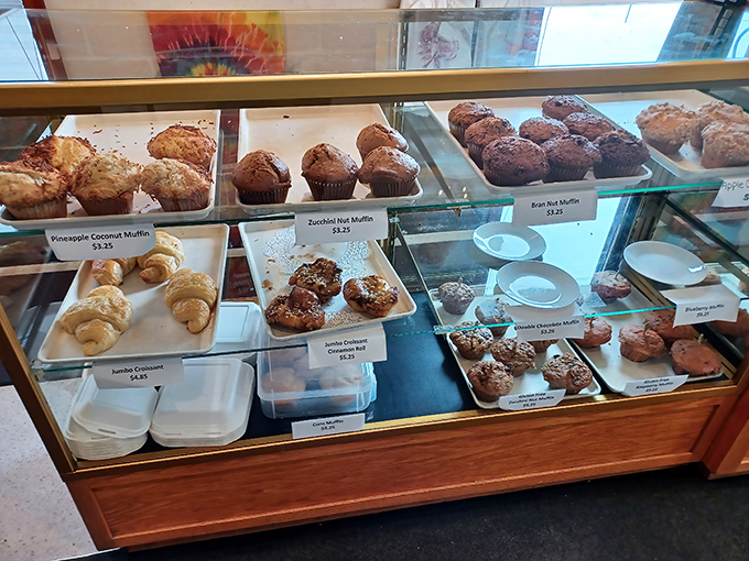 Muffins and pastries lined up like contestants in a delicious beauty pageant. The hardest decision you'll make all day awaits behind this glass.
