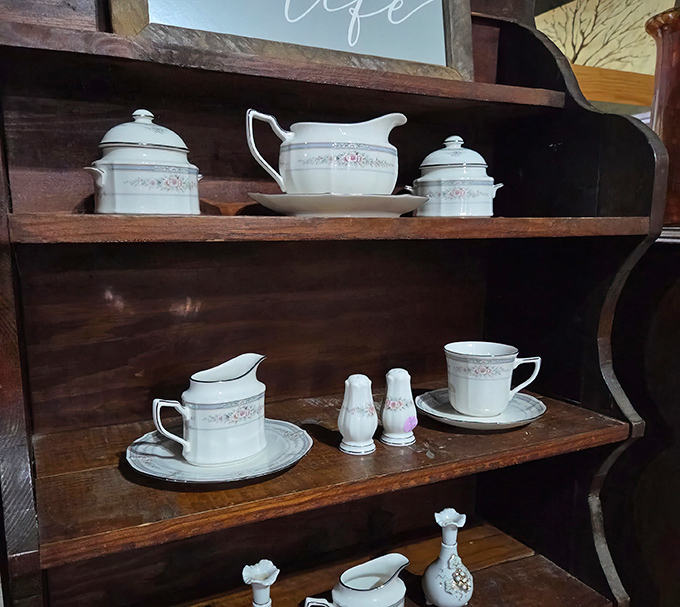 Delicate porcelain pieces arranged on shelves that understand the assignment: make everything look irresistibly charming.