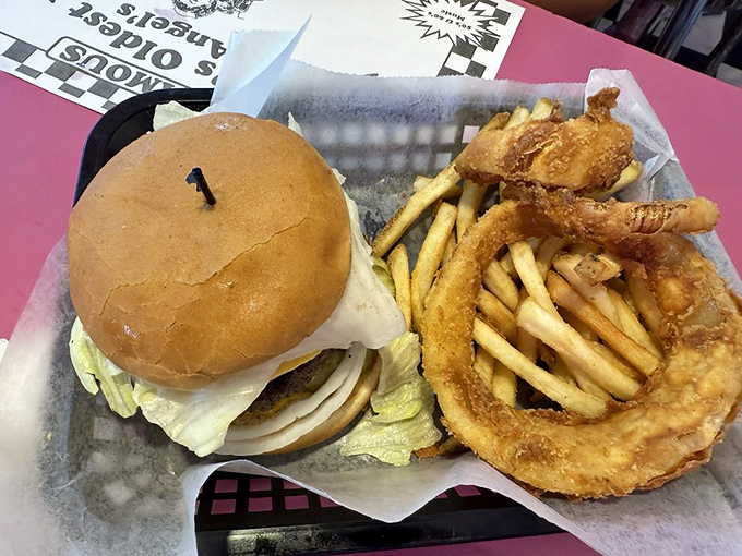 The burger that launched a thousand road trips. Paired with golden fries and crispy onion rings, it's the holy trinity of diner perfection.
