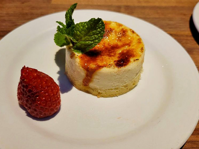 Cr&egrave;me br&ucirc;l&eacute;e cheesecake with a strawberry sidekick&mdash;dessert diplomacy at its finest as two classics form a delicious alliance.