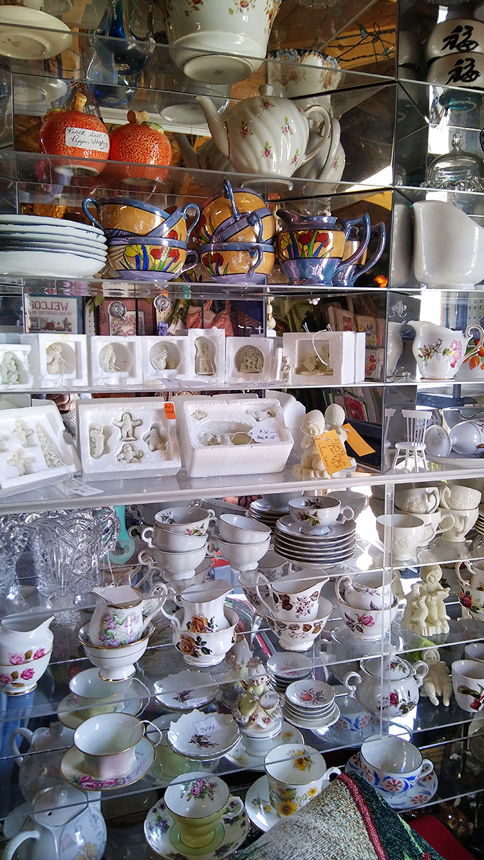 Delicate teacups and saucers stacked with precision, each one whispering stories of afternoon gatherings and pinky-raised conversations.