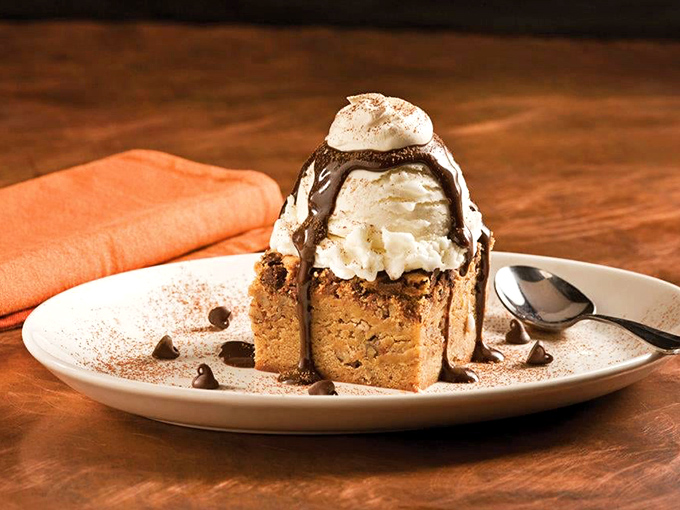 A warm chocolate blondie crowned with ice cream and chocolate sauce &ndash; dessert architecture that deserves both a photo and your undivided attention.