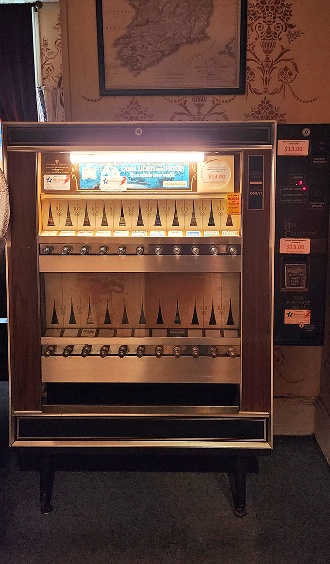 A vintage cigarette machine stands as a quirky relic of bygone days, now repurposed as part of the pub's nostalgic charm.