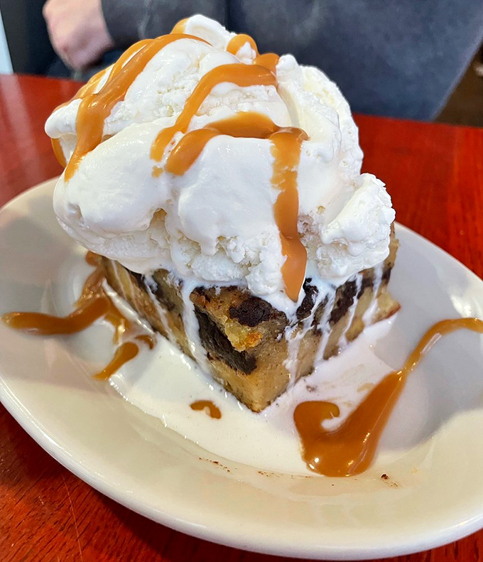 Bread pudding that makes you question why you've wasted time on lesser desserts, crowned with ice cream melting into a river of sweet surrender.