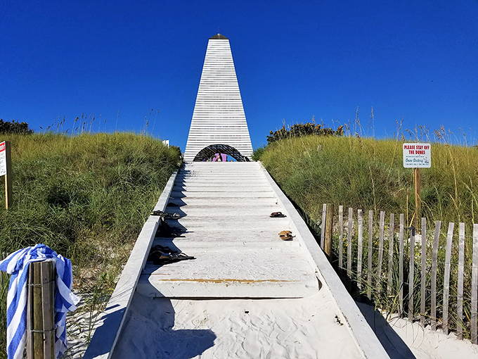 The pyramid-shaped Coleman Beach Pavilion creates a dramatic entrance to the Gulf, like a geometric doorway between civilization and the endless horizon of turquoise water beyond.