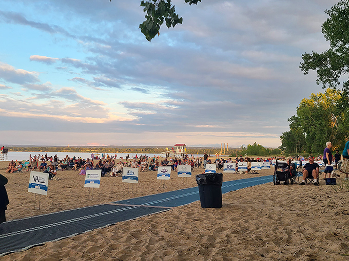 As sunset approaches, the beach transforms into an impromptu community gathering space, where strangers become neighbors under painted skies.