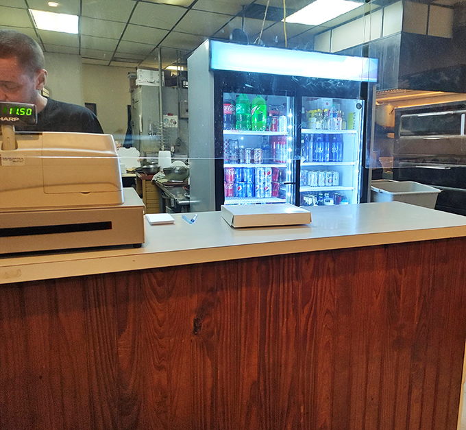 The humble command center where orders are taken and pizza magic begins. No fancy digital systems here—just good old-fashioned service that gets it right.