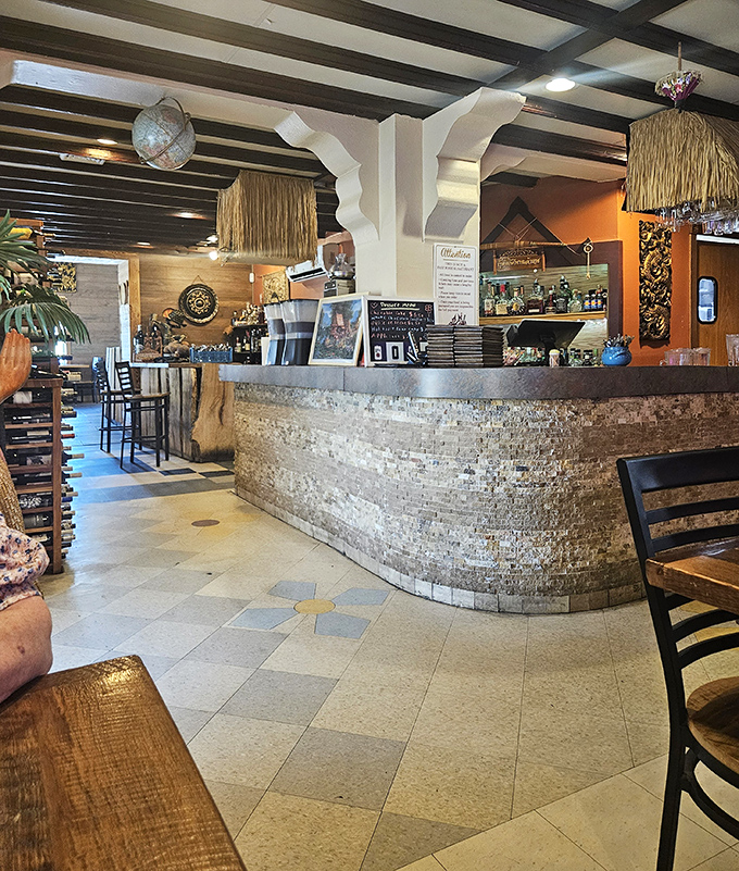 The host station welcomes with stone-faced elegance, while thatched accents overhead remind you this isn't your average Lima dining experience.