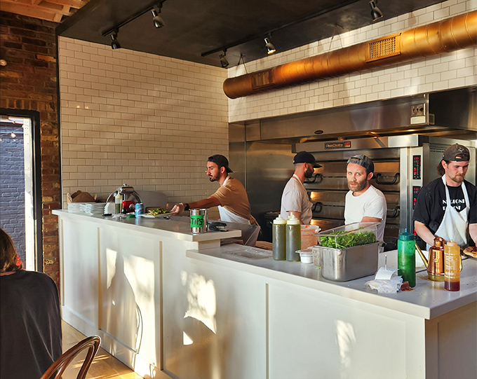 The open kitchen isn't just functional &ndash; it's dinner and a show, where pizza-making becomes performance art worth watching.
