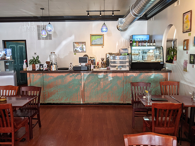 The counter's weathered turquoise patina tells stories of countless coffee refills and the patient crafting of morning masterpieces just beyond.