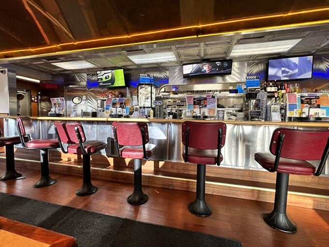 The counter seating offers front-row tickets to the culinary show&mdash;red swivel chairs and stainless steel backdrop creating that quintessential diner experience.