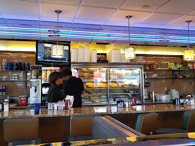 The counter and bakery display&mdash;where willpower goes to die and "I'll just have coffee" turns into "and a slice of that cake, please."